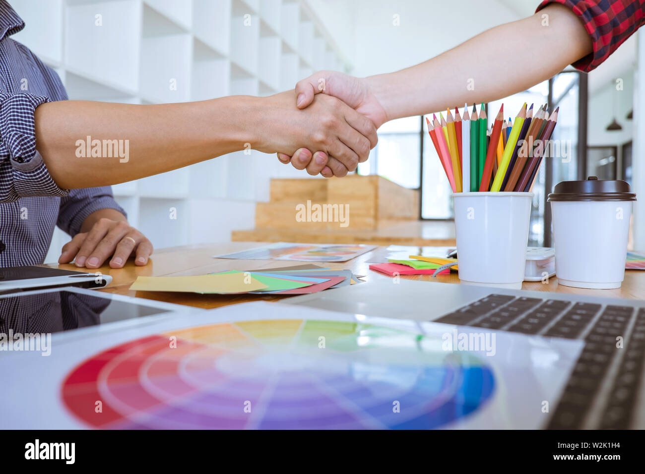 Cooperation of Young creative graphic designer working on workspace and ...