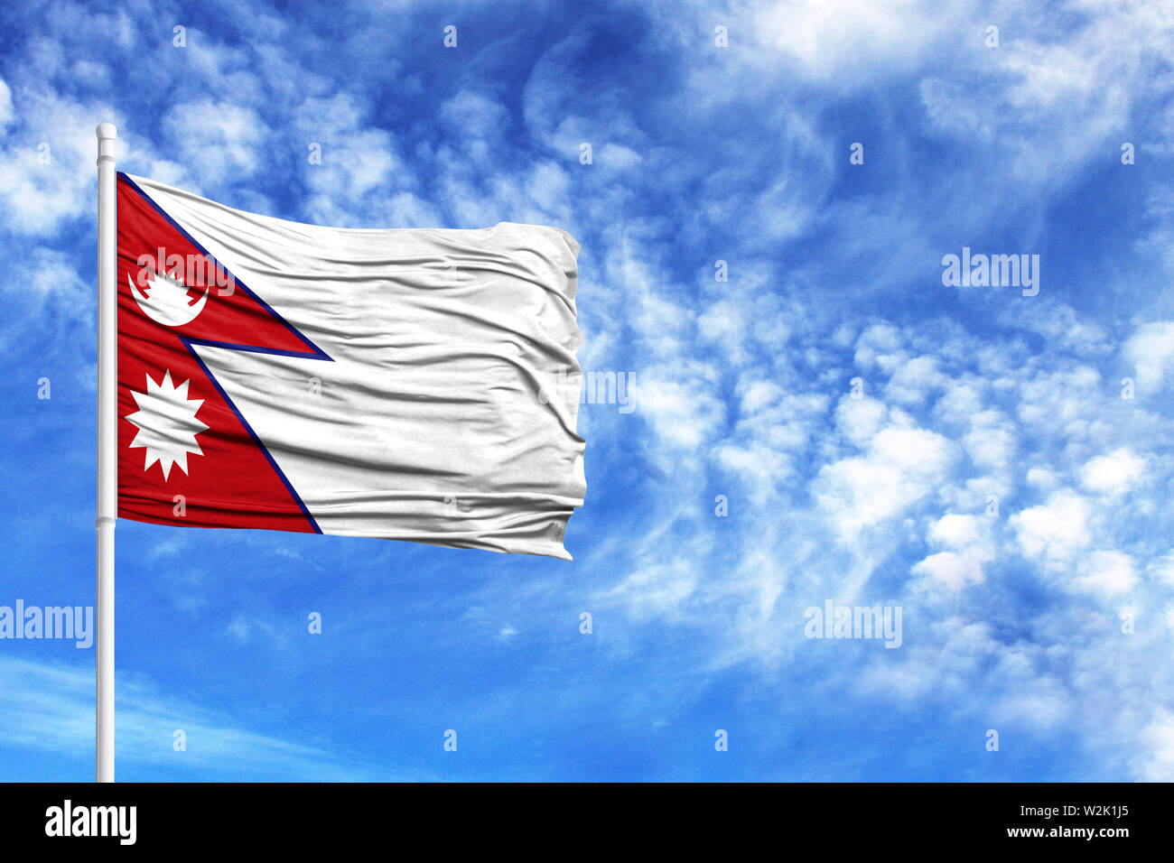 National flag of Nepal on a flagpole in front of blue sky Stock Photo ...