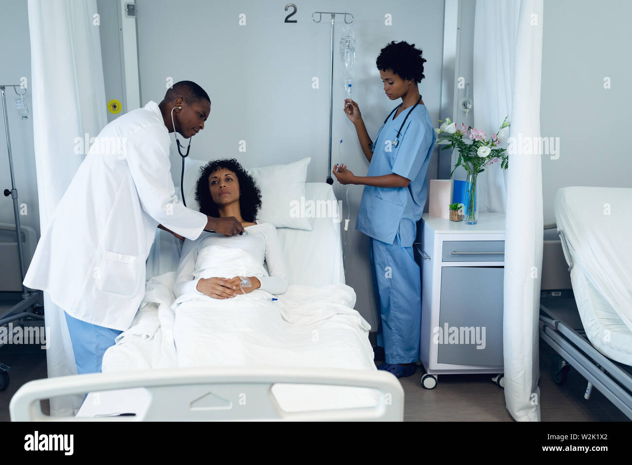 Male doctor examining female patient with stethoscope in the ward Stock ... Male doctor examining female patient with stethoscope in the ward Stock ...
