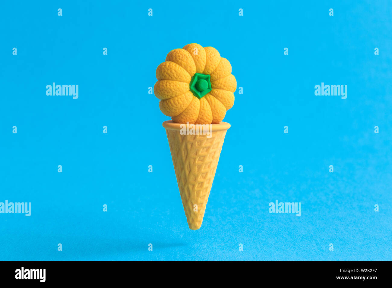 Ice cream cone with squash against pastel blue background minimal food ...