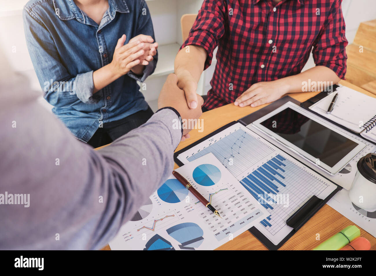 Finishing up a meeting, handshake of two happy business people after contract agreement to ...