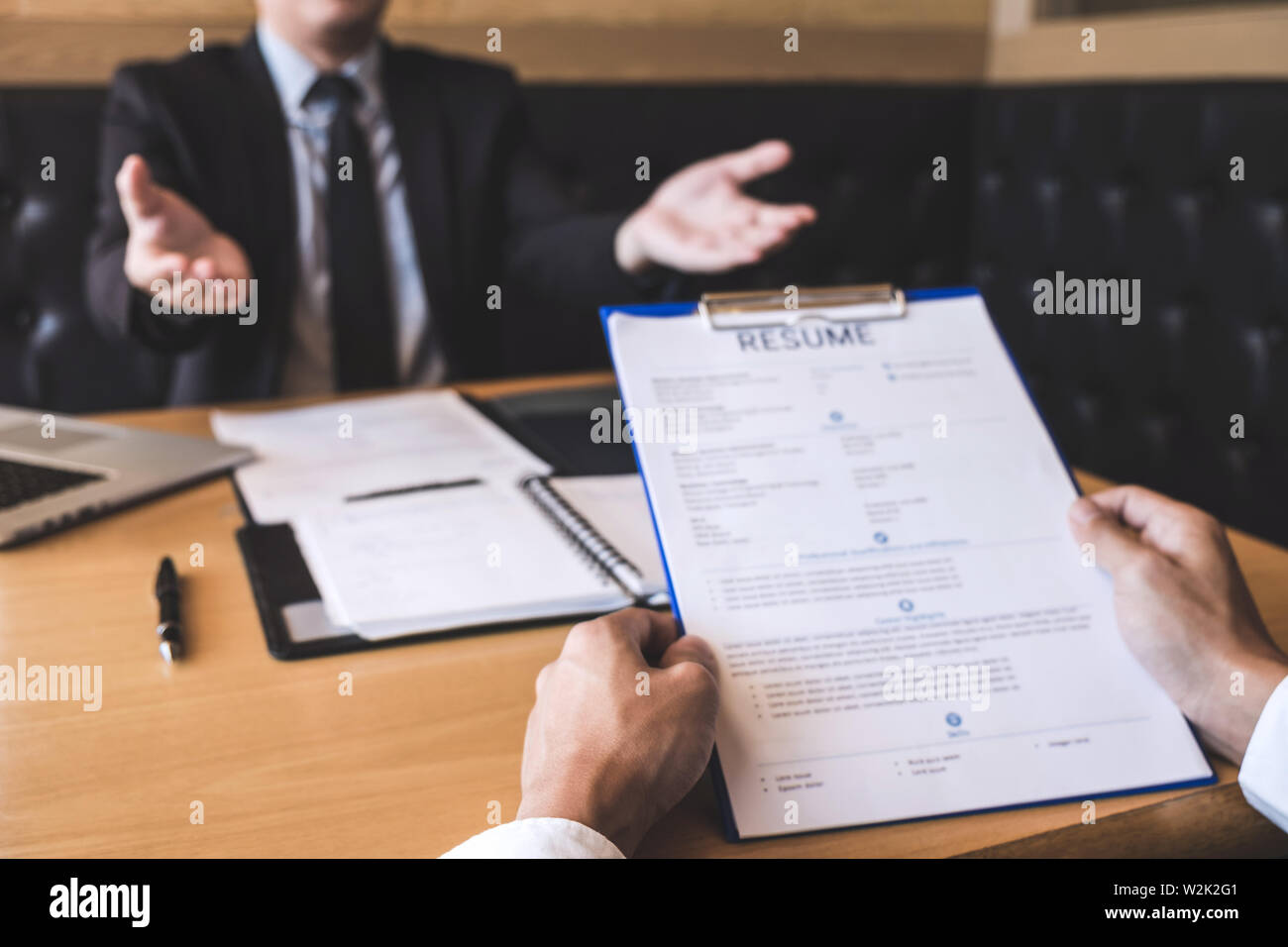 Employer or recruiter holding reading a resume during about his profile ...