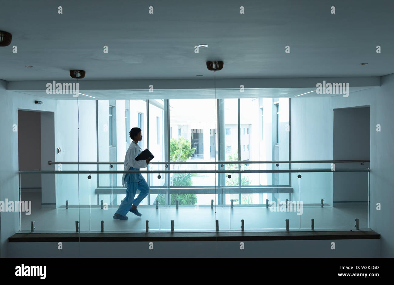 Female doctor running in the corridor at hospital Stock Photo - Alamy