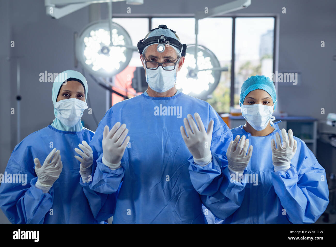 Surgeons gesturing while standing in operating room at hospital Stock ...