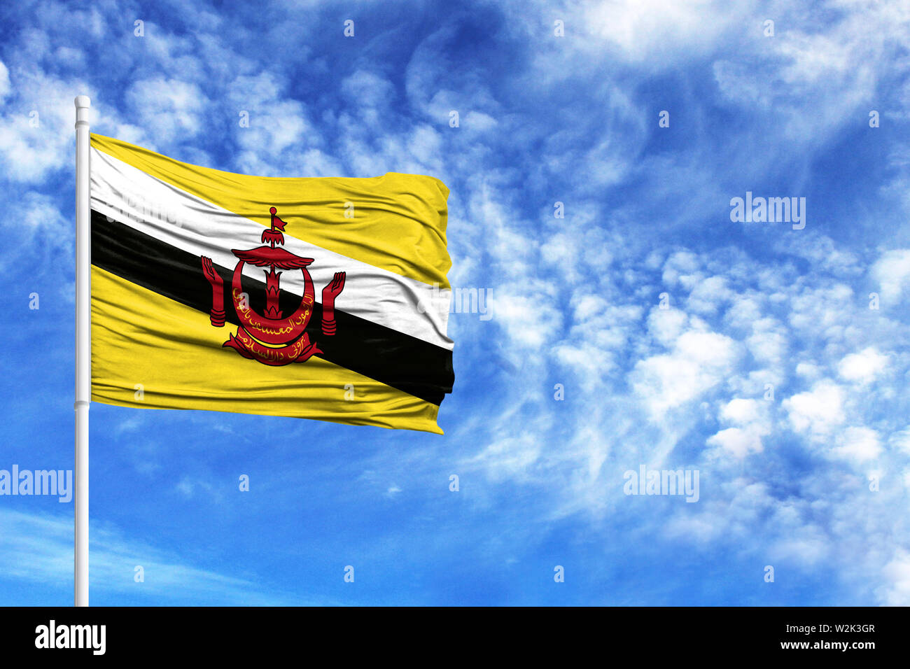 National flag of Brunei on a flagpole in front of blue sky Stock Photo ...