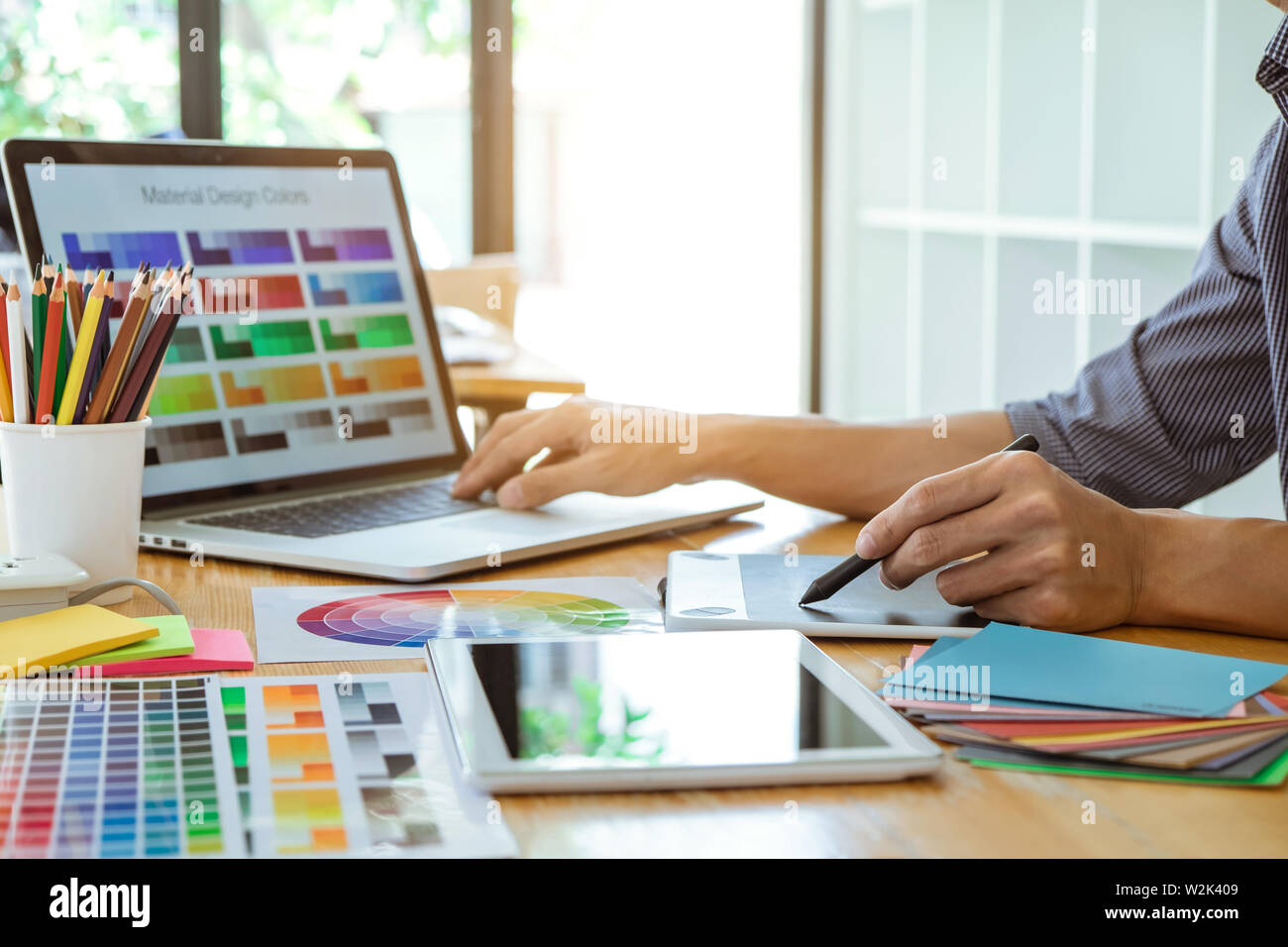 Young creative graphic designer working on project architectural ...