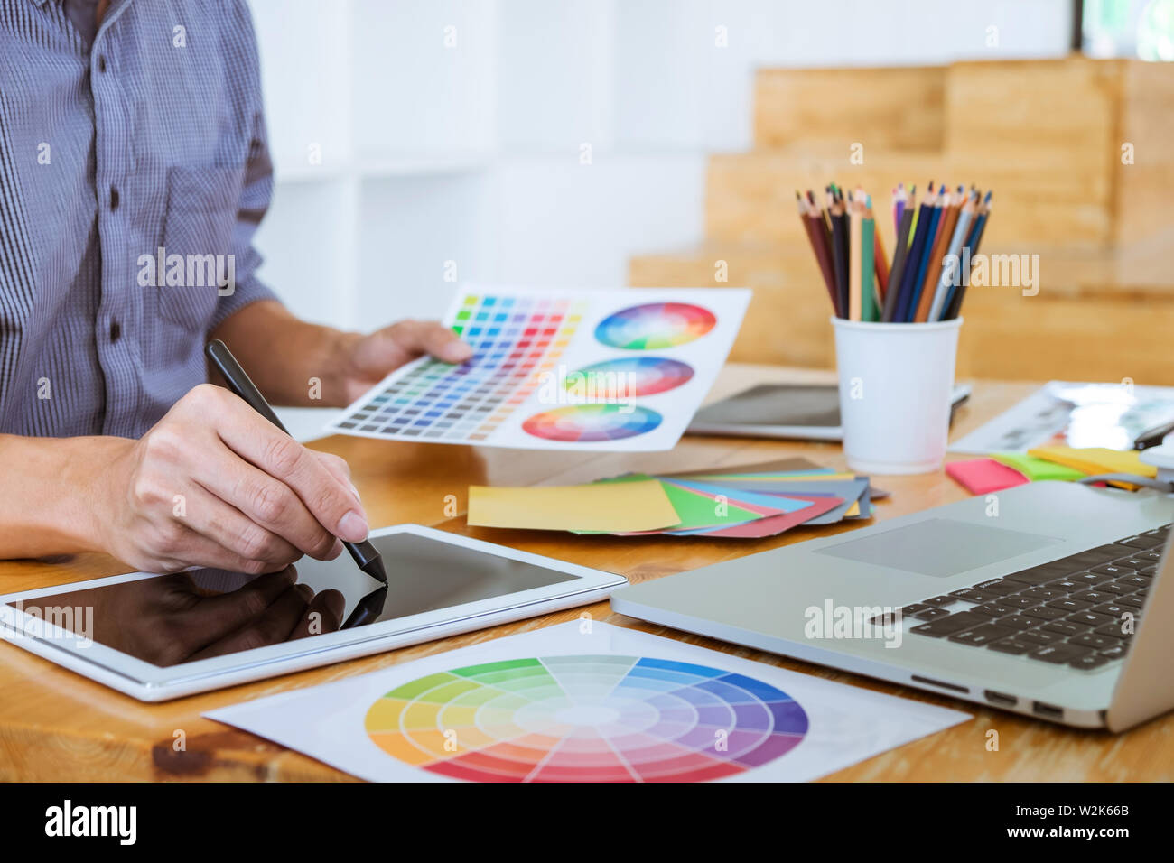 Young creative graphic designer working on project architectural ...