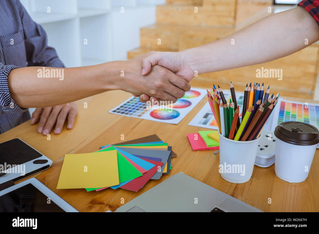 Cooperation of Young creative graphic designer working on workspace and ...