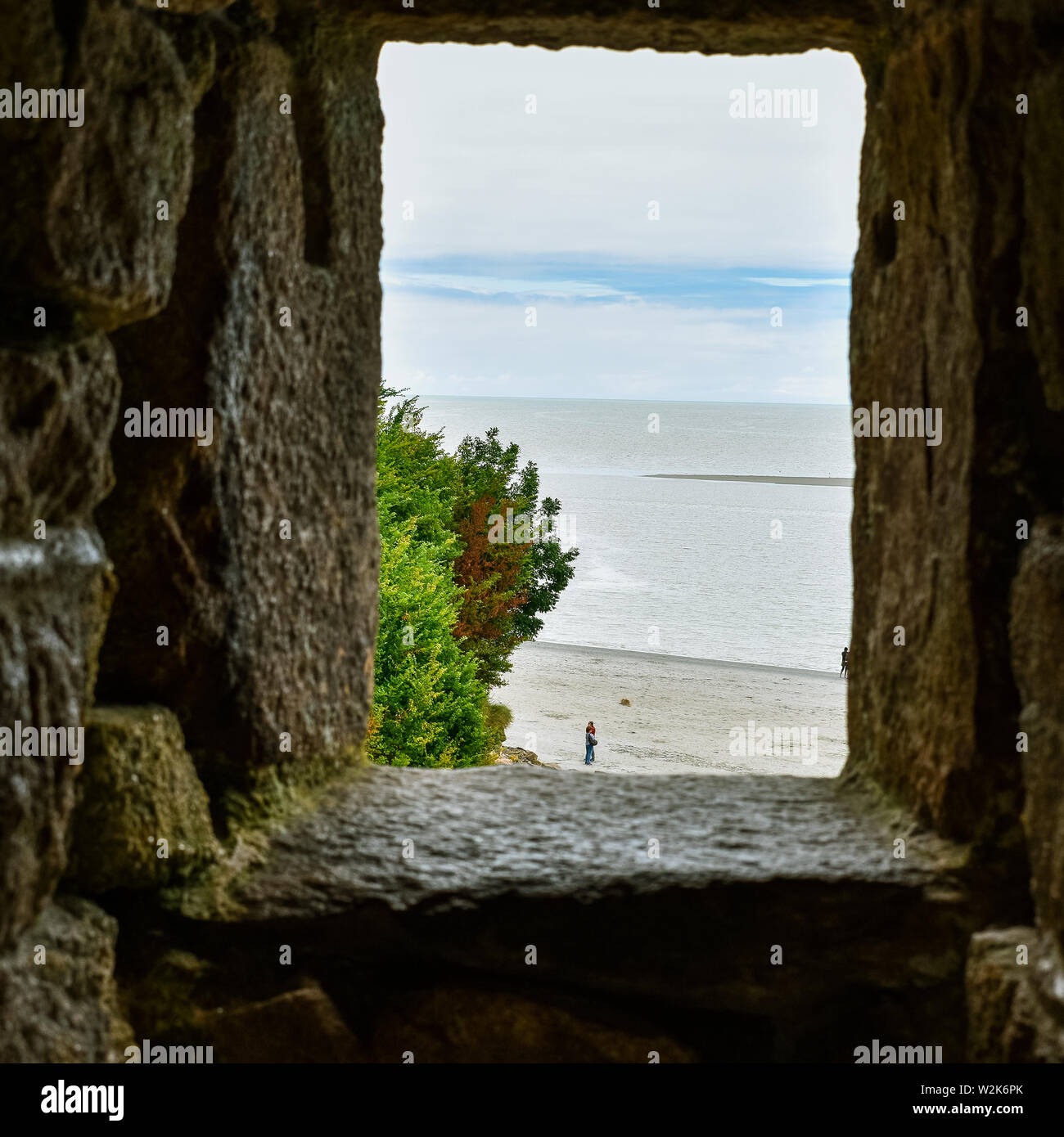 Looking at the sea and the blue sky through a stone window. Sensation ...