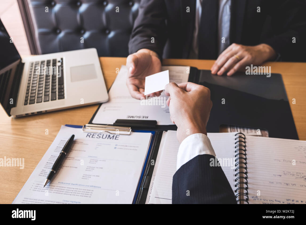 Employer or recruiter holding reading a resume during about his profile ...