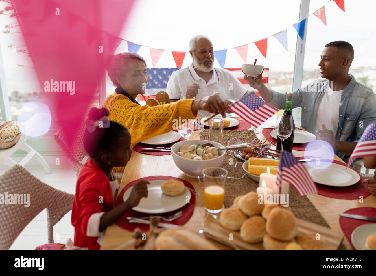 Multi-generation family having food together on a dining table Stock ...