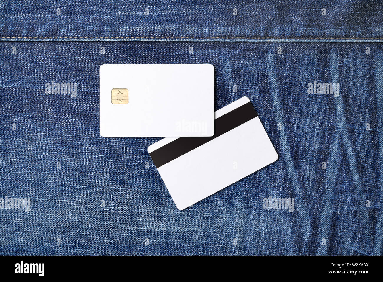 Bank white plastic chip cards on denim background. Two credit cards ...