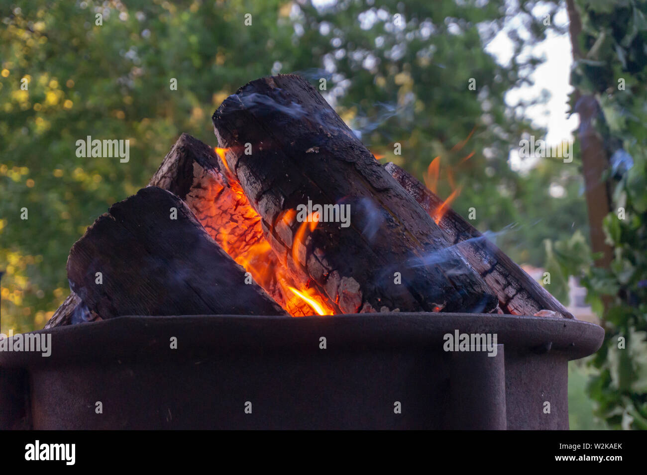 Low angle ground level view of a blazing camp fire with orange flames ...