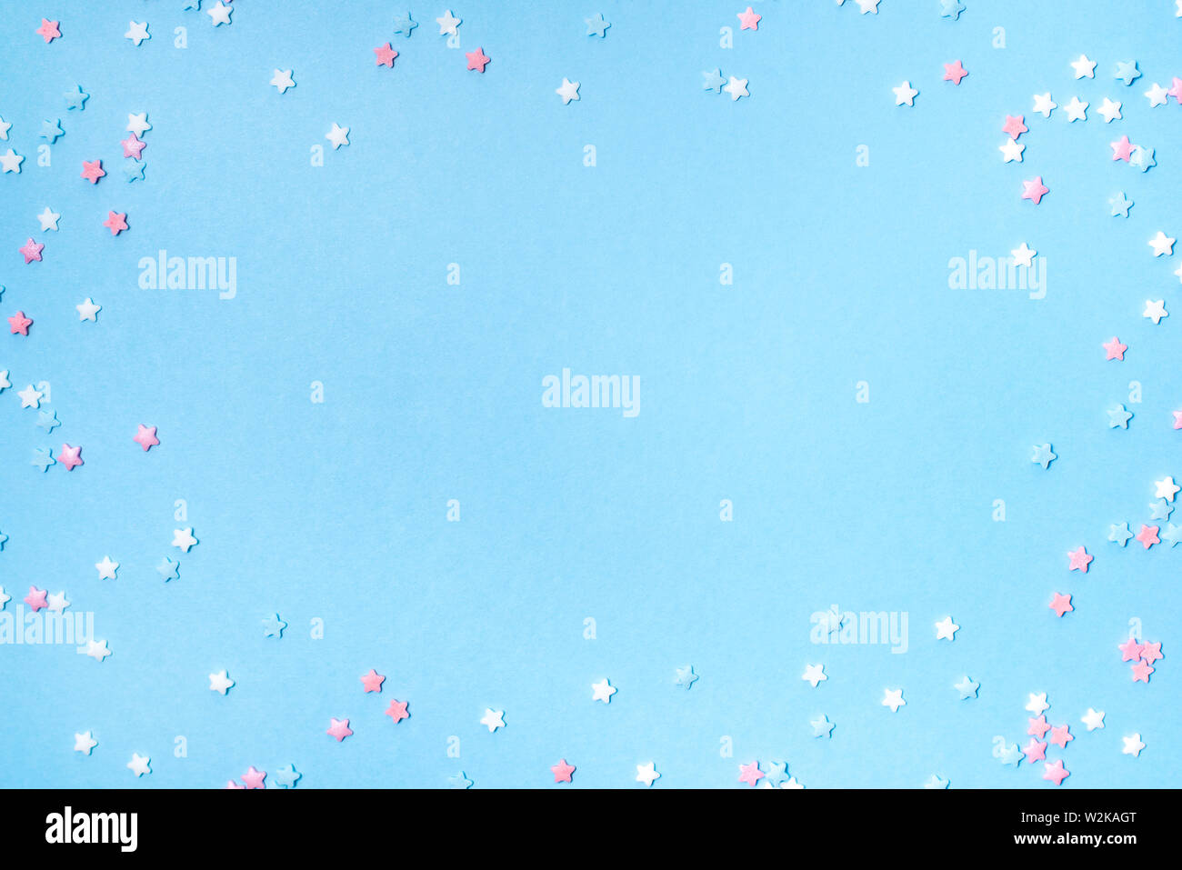 Little stars confetti on blue background Stock Photo - Alamy