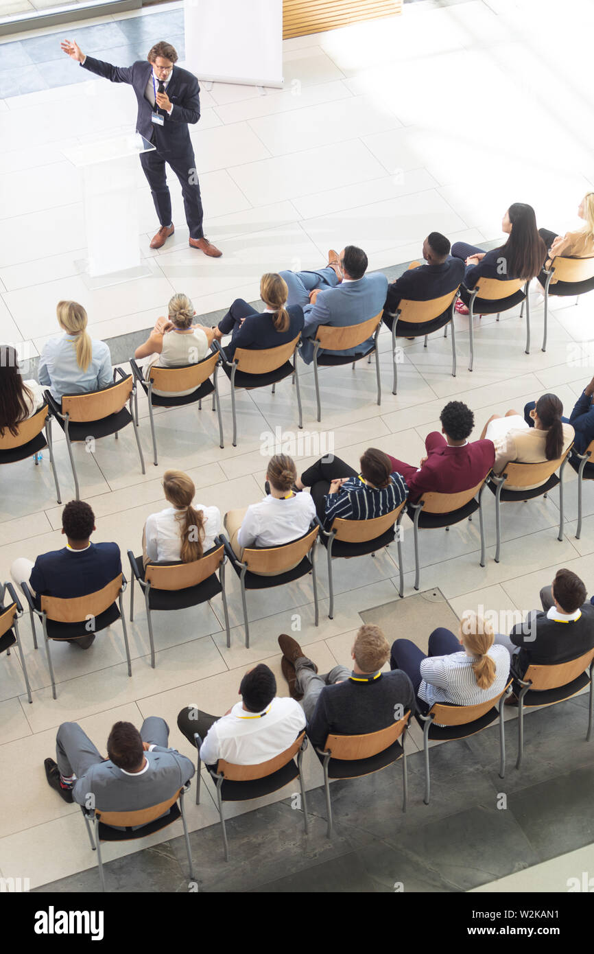 Diverse executives sat in conference room, looking speech Stock Photo ...