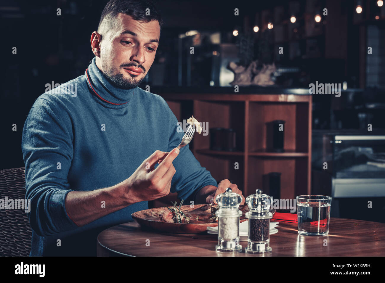 Handsome man eating at the restaurant Stock Photo - Alamy