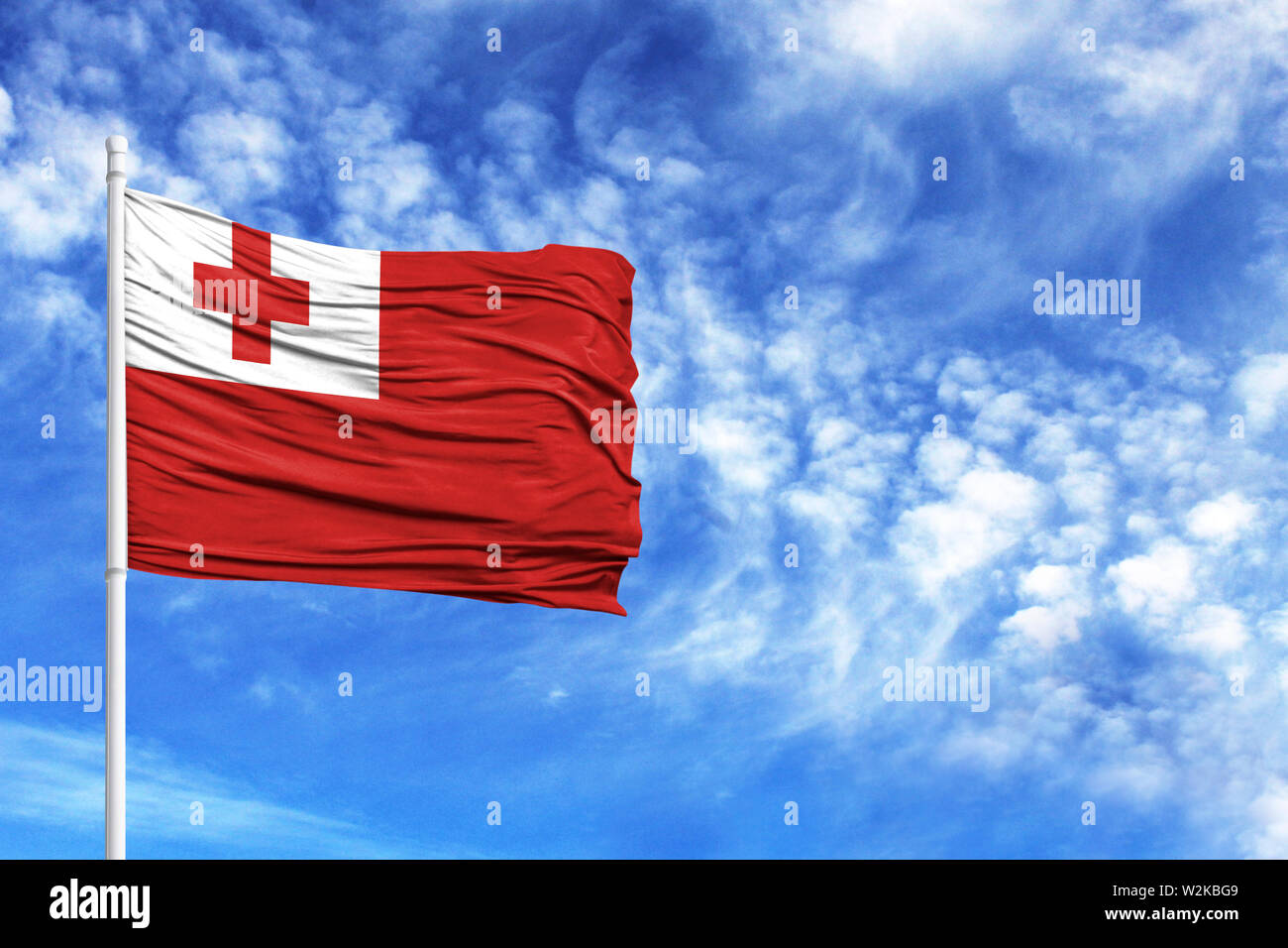 National flag of Tonga on a flagpole in front of blue sky Stock Photo ...