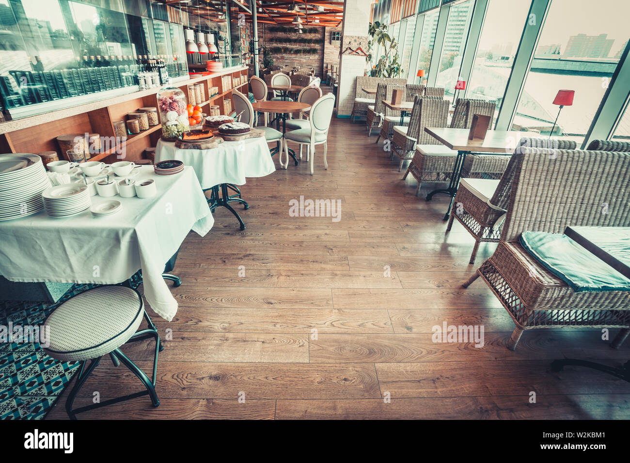 Interior of modern restaurant with tables, chairs and tableware Stock ...