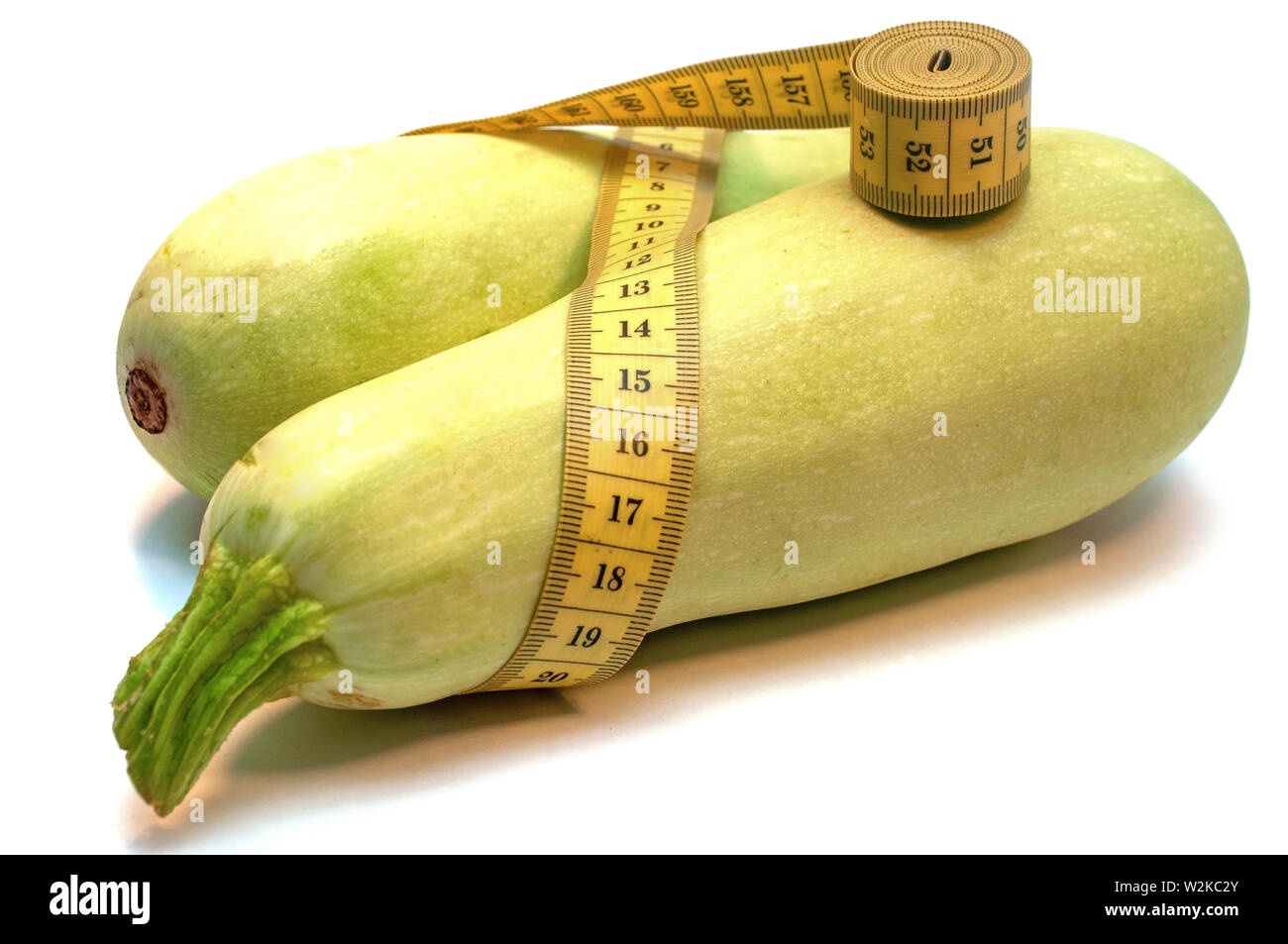 Courgettes and measuring tape isolated on white background Stock Photo ...