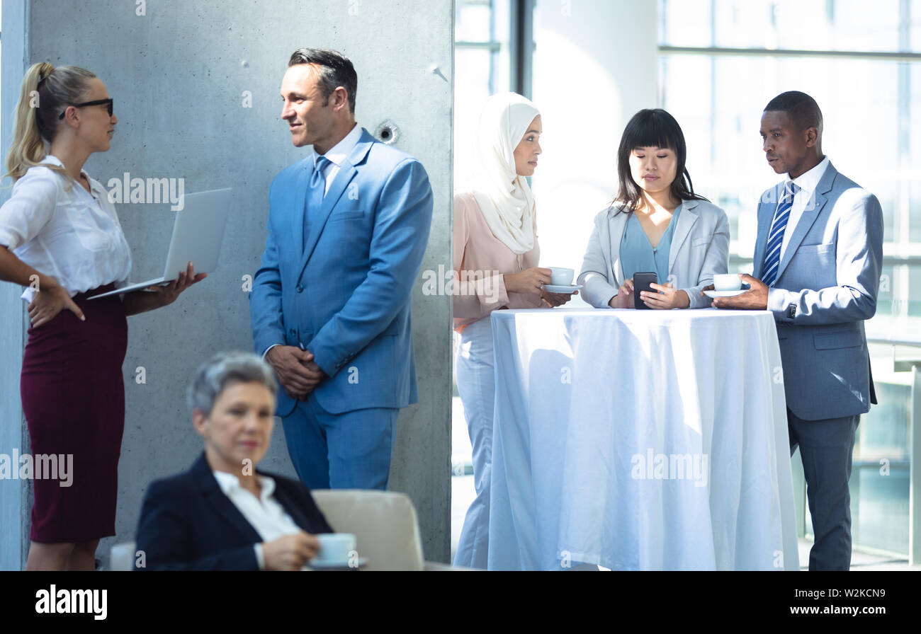 Groups of diverse colleagues interacting with each other Stock Photo ...
