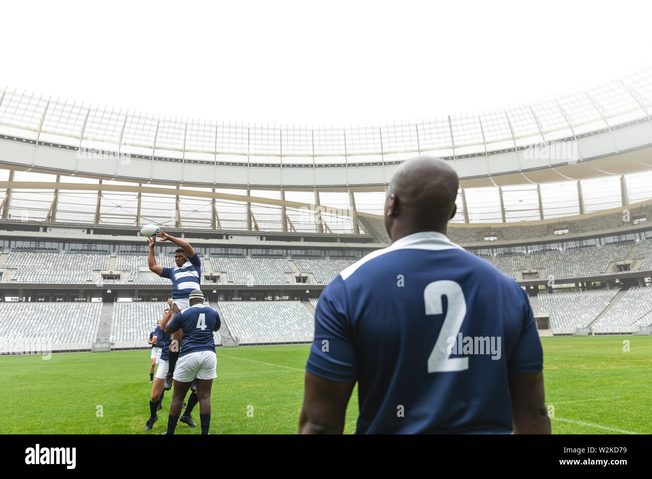Group of diverse male rugby player playing rugby match in stadium Stock ...