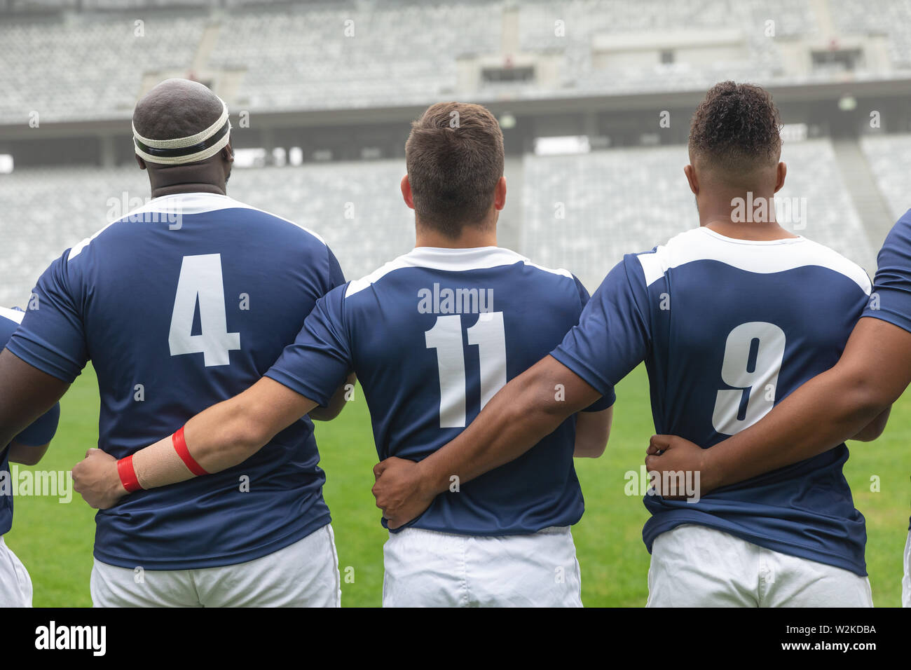 Diverse Male rugby players taking pledge together in stadium Stock ...