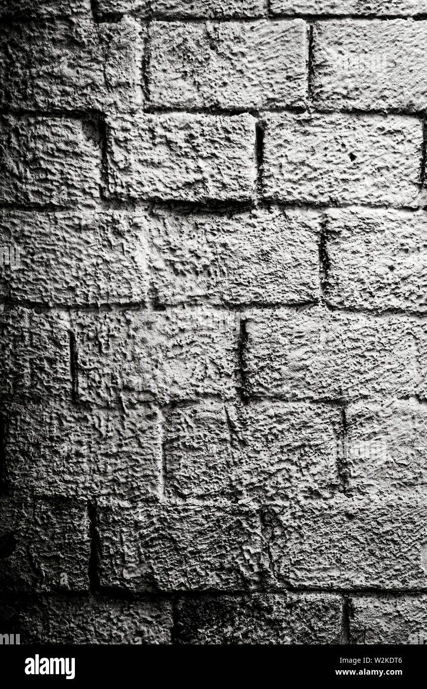 Old black and white painted brick wall Stock Photo - Alamy