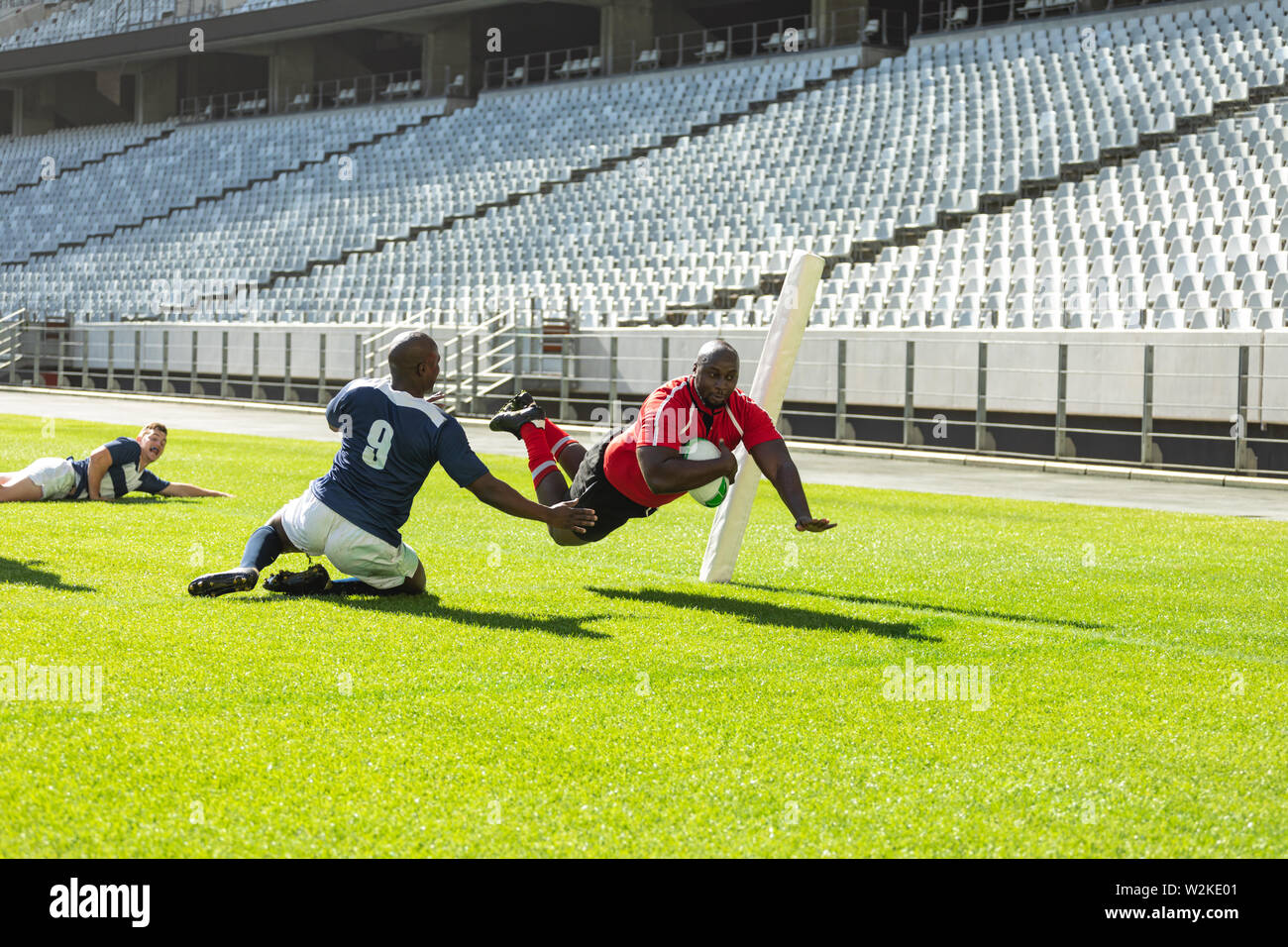 Male rugby players playing rugby match in stadium Stock Photo - Alamy
