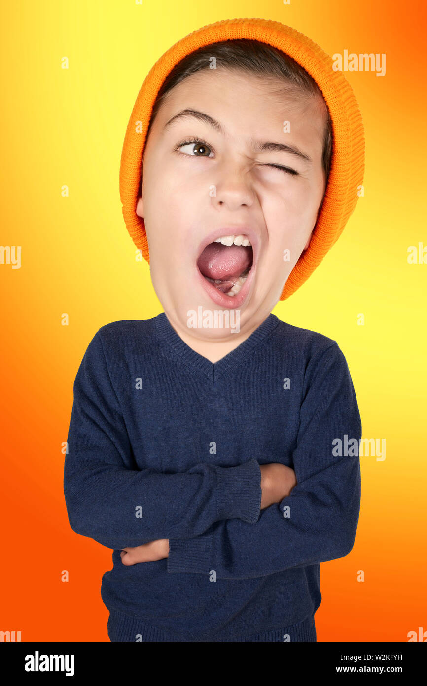portrait of yawning young boy with big head on orange background Stock ...