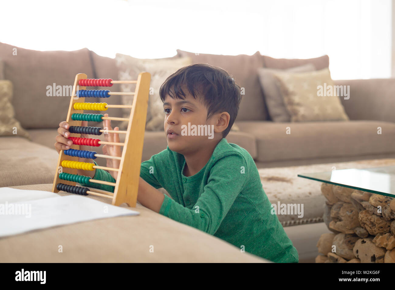 Boy learning mathematics with abacus in a comfortable home Stock Photo ...