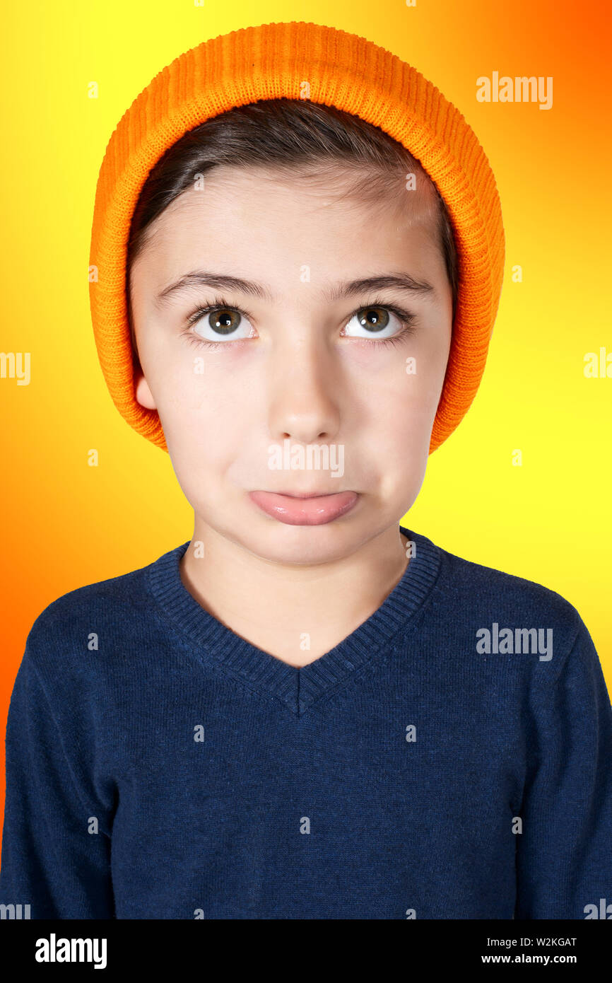 portrait of pouting young boy with big head on orange background Stock Photo - Alamy