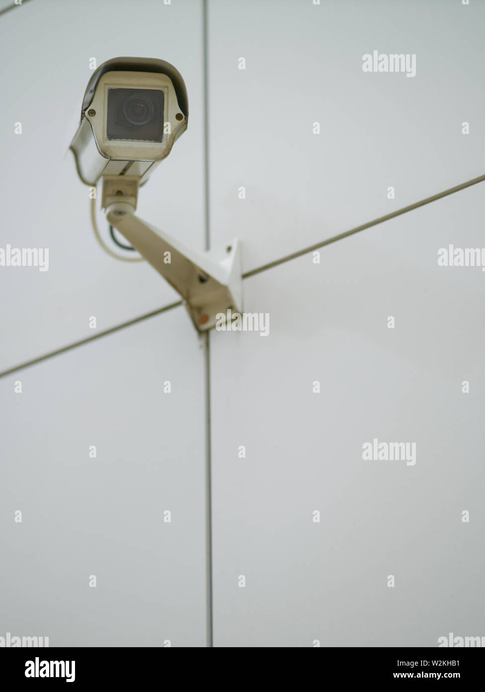 Outdoor surveillance camera, mounted on the wall of the building ...