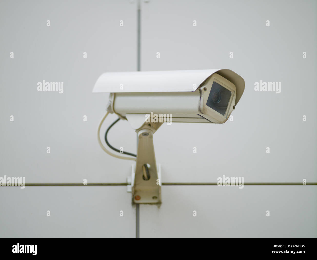 Outdoor surveillance camera, mounted on the wall of the building ...
