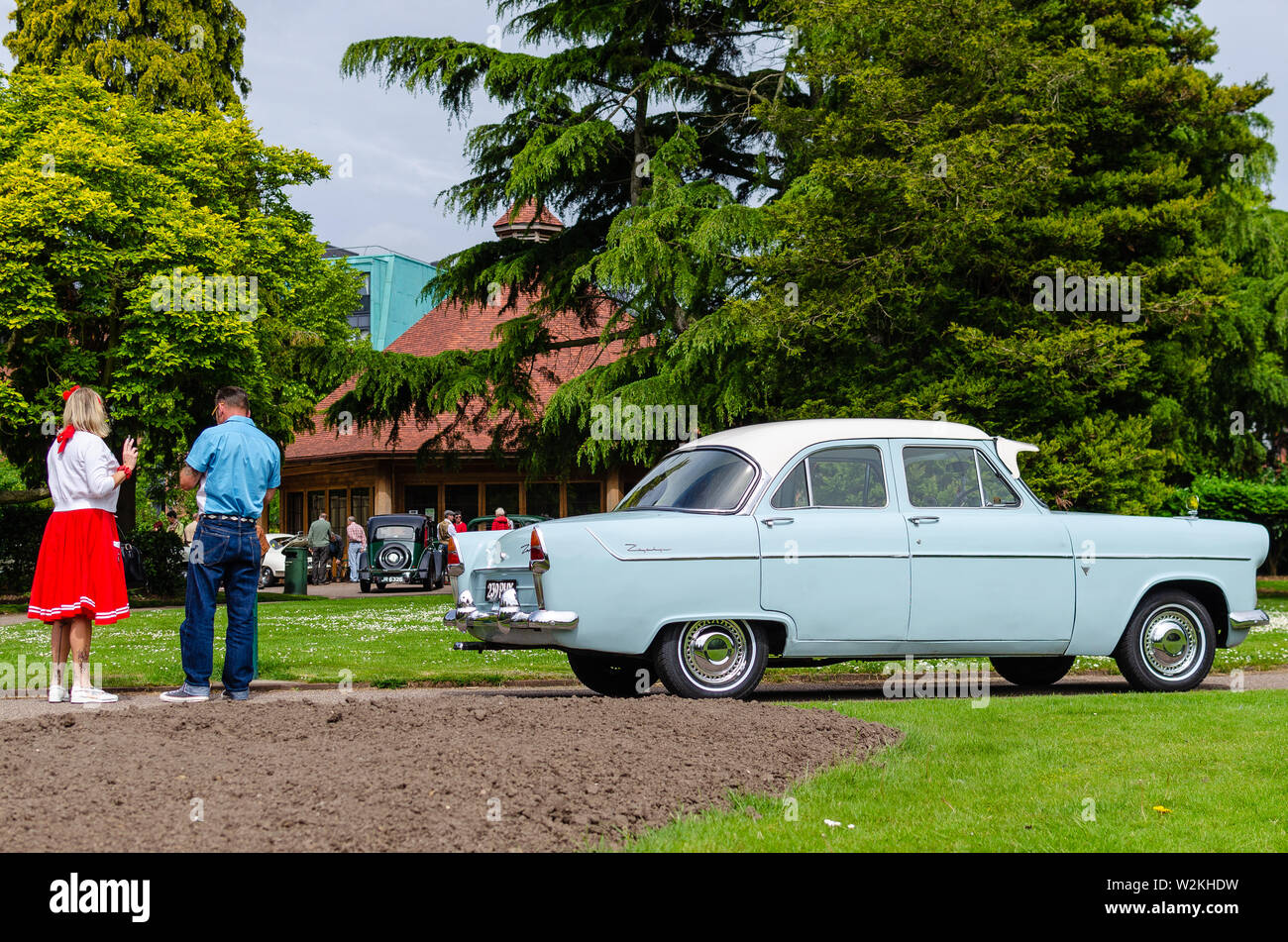 The luxury classic car and a couple standing next to it. Classic cars ...