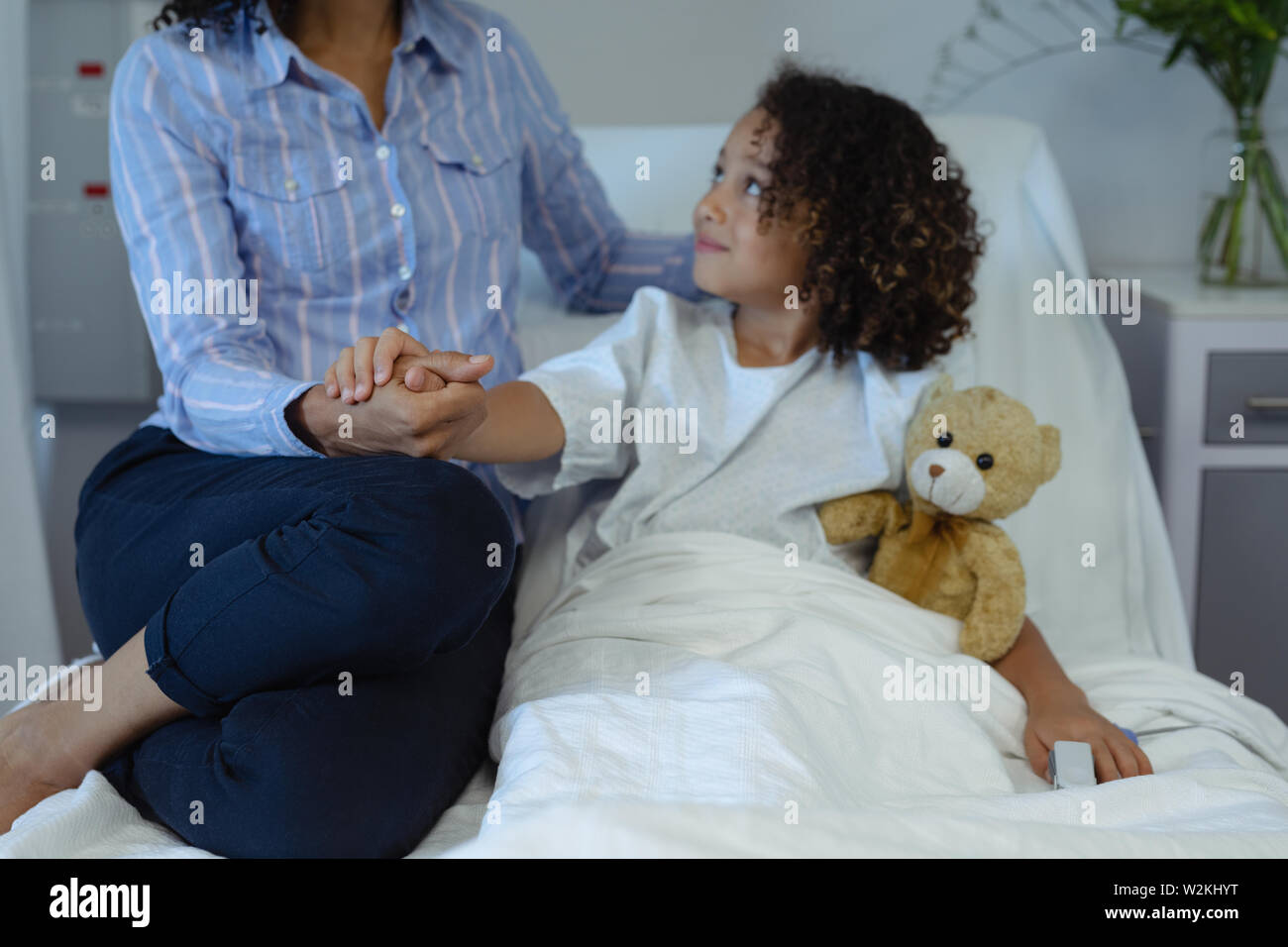 Mother holding hand of her son in the ward Stock Photo - Alamy