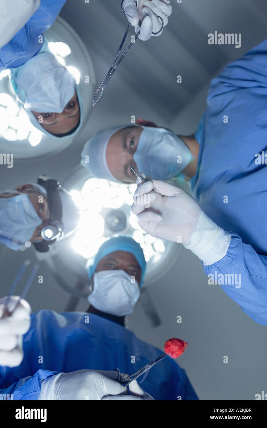 Surgeons performing surgery in operation theater at hospital Stock ...