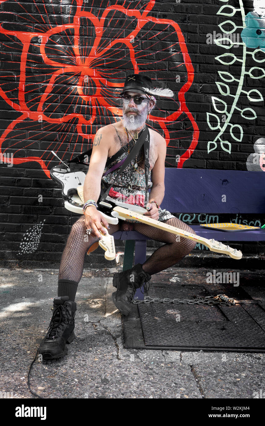 A Portrait Of An Eccentric Adult Man Dressed In Unusual Clothes On