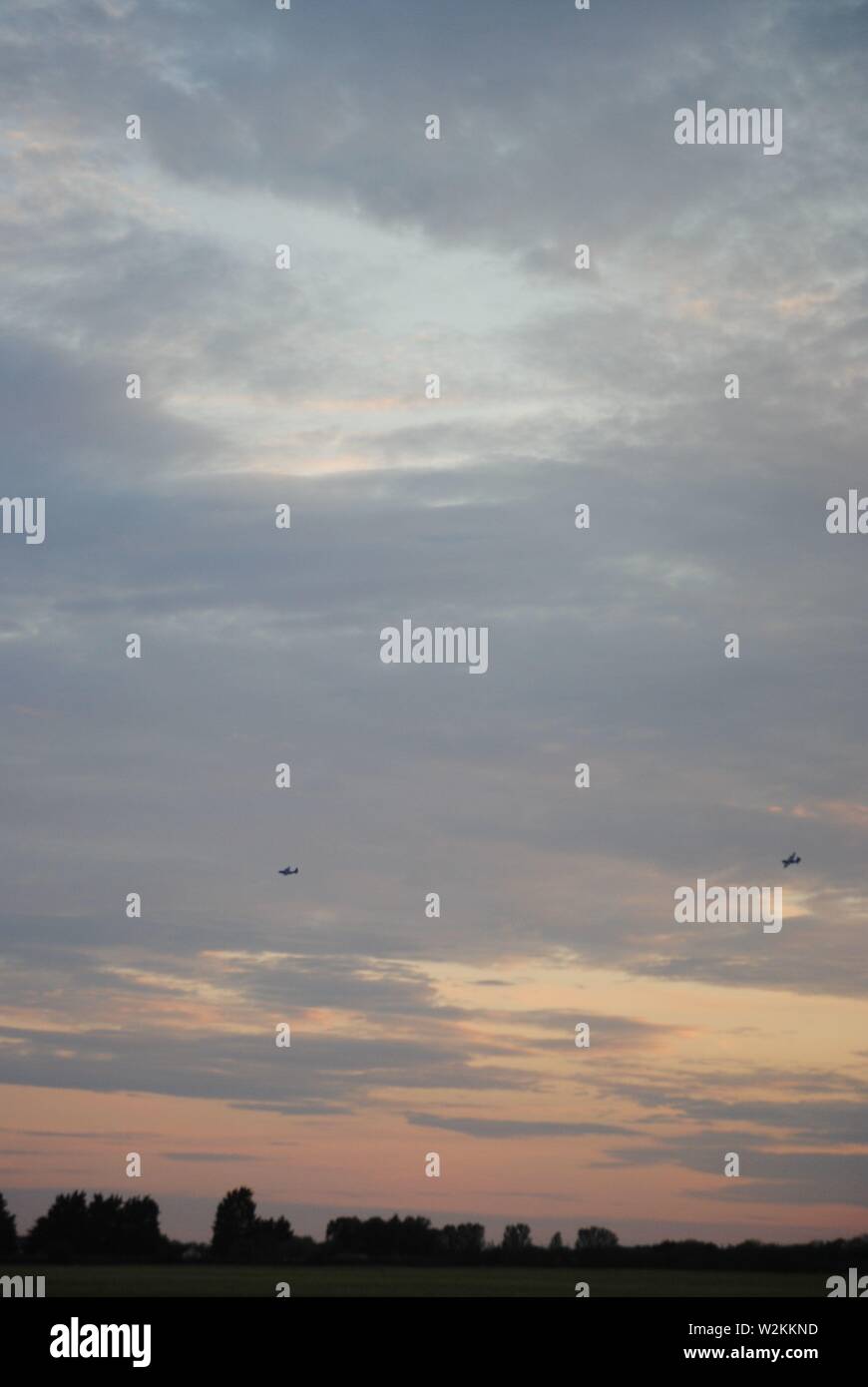 pair of C 130 Hercules aircraft in the sky of a sunsetting sky with ...