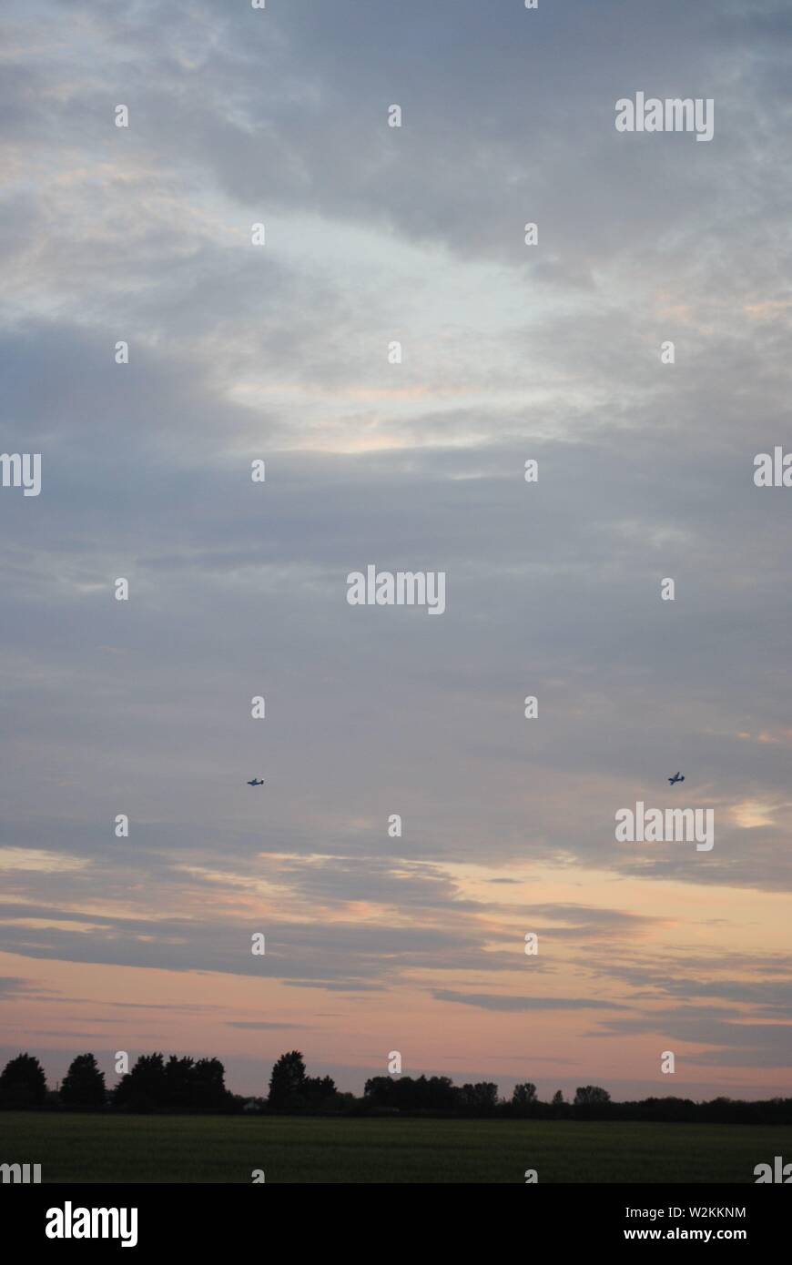 pair of C 130 Hercules aircraft in the sky of a sunsetting sky with ...