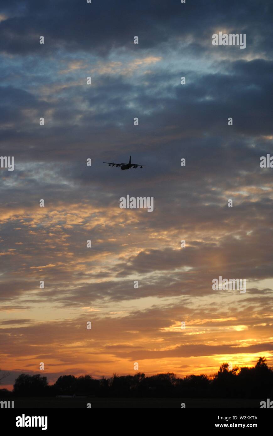 pair of C 130 Hercules aircraft in the sky of a sunsetting sky with ...