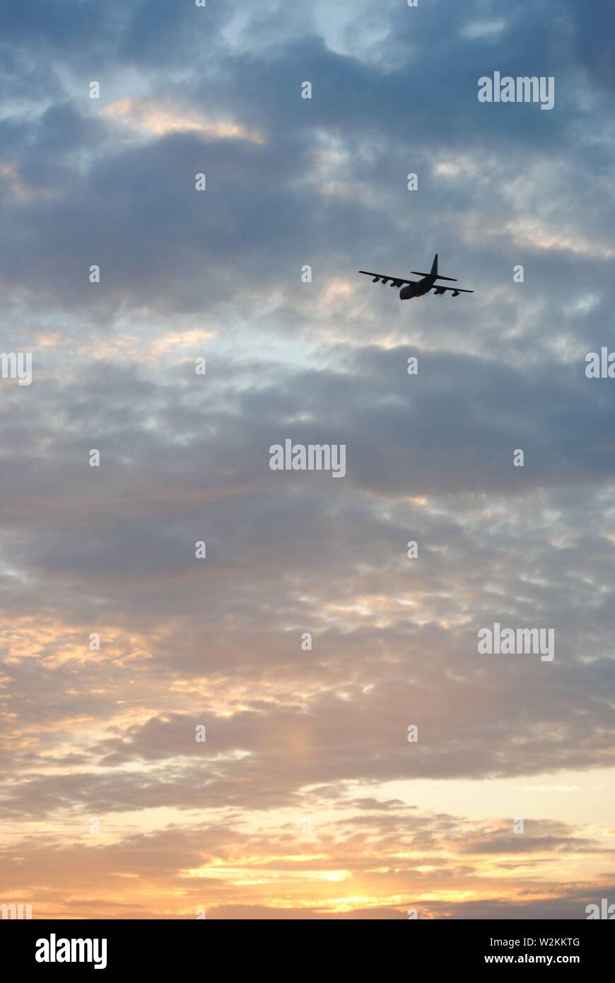 pair of C 130 Hercules aircraft in the sky of a sunsetting sky with ...