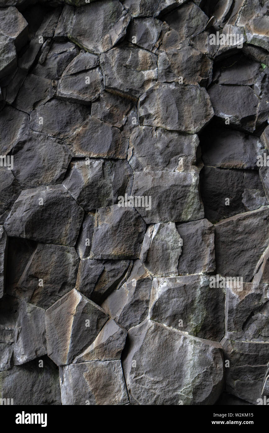 Close up view of hexagonal basalt columns on Reynisfjara black sand beach, southern Iceland ...