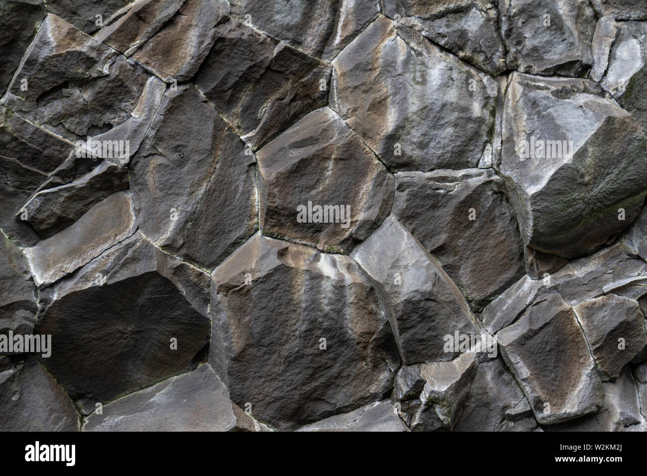Close up view of hexagonal basalt columns on Reynisfjara black sand beach, southern Iceland ...