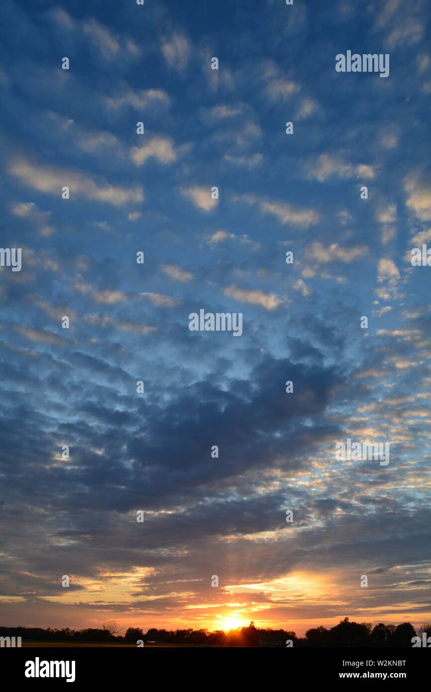a collection of shots of the sun setting over the flat Suffolk fields ...