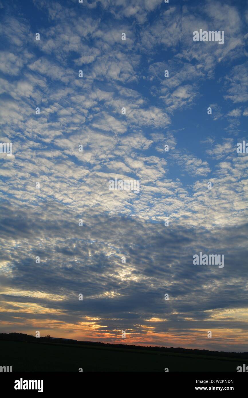 a collection of shots of the sun setting over the flat Suffolk fields ...