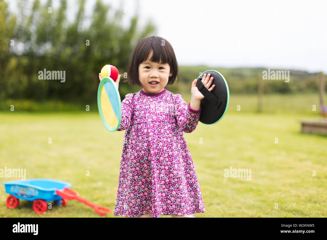 toddler girl playing catch it target game at summer garden Stock Photo ...