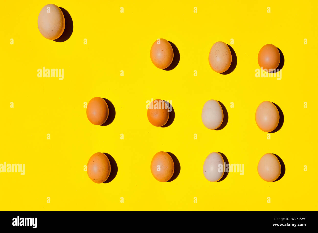 An eggs pattern. A different sizes eggs on a yellow background ...