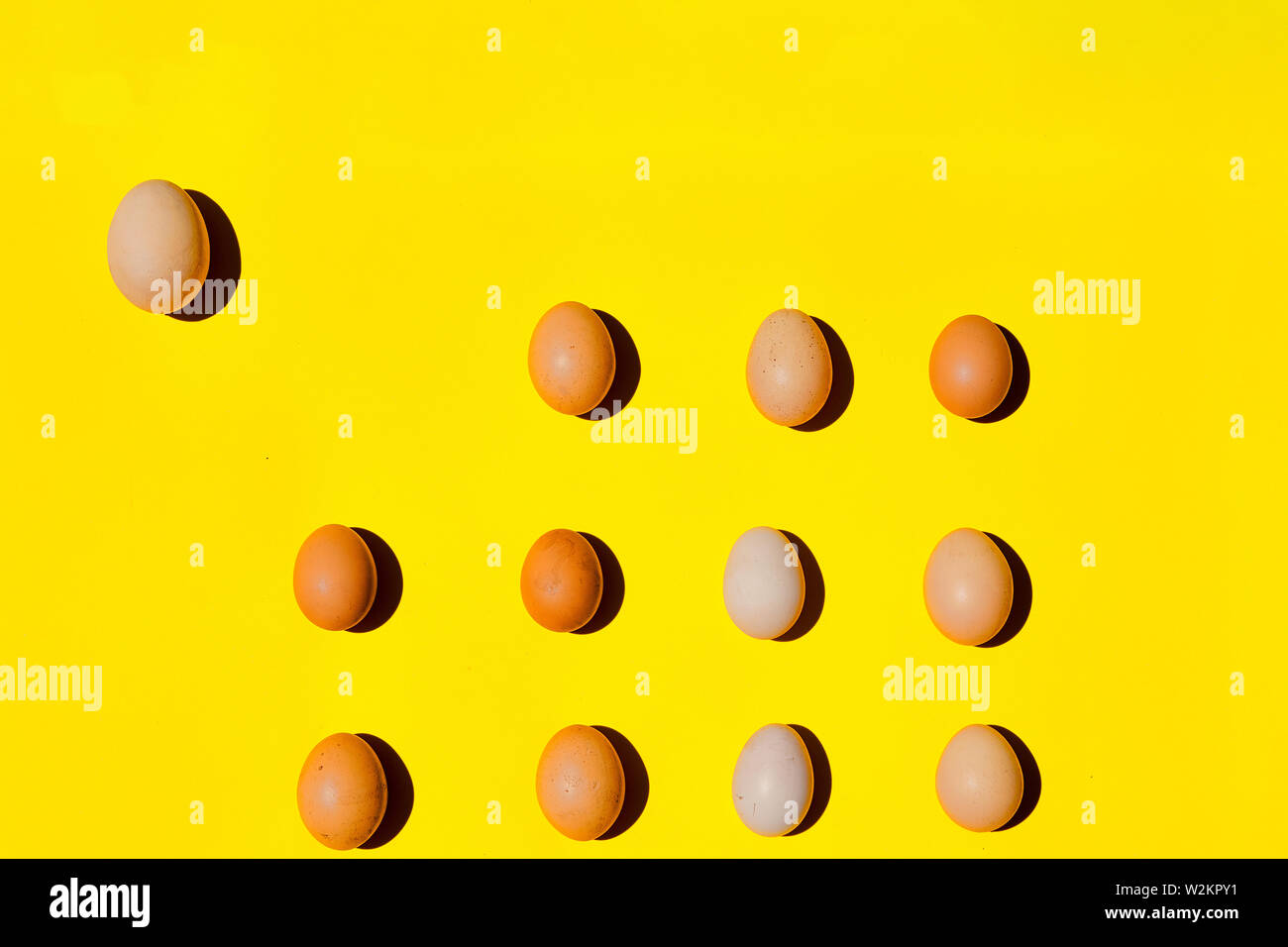 An eggs pattern. A different sizes eggs on a yellow background ...