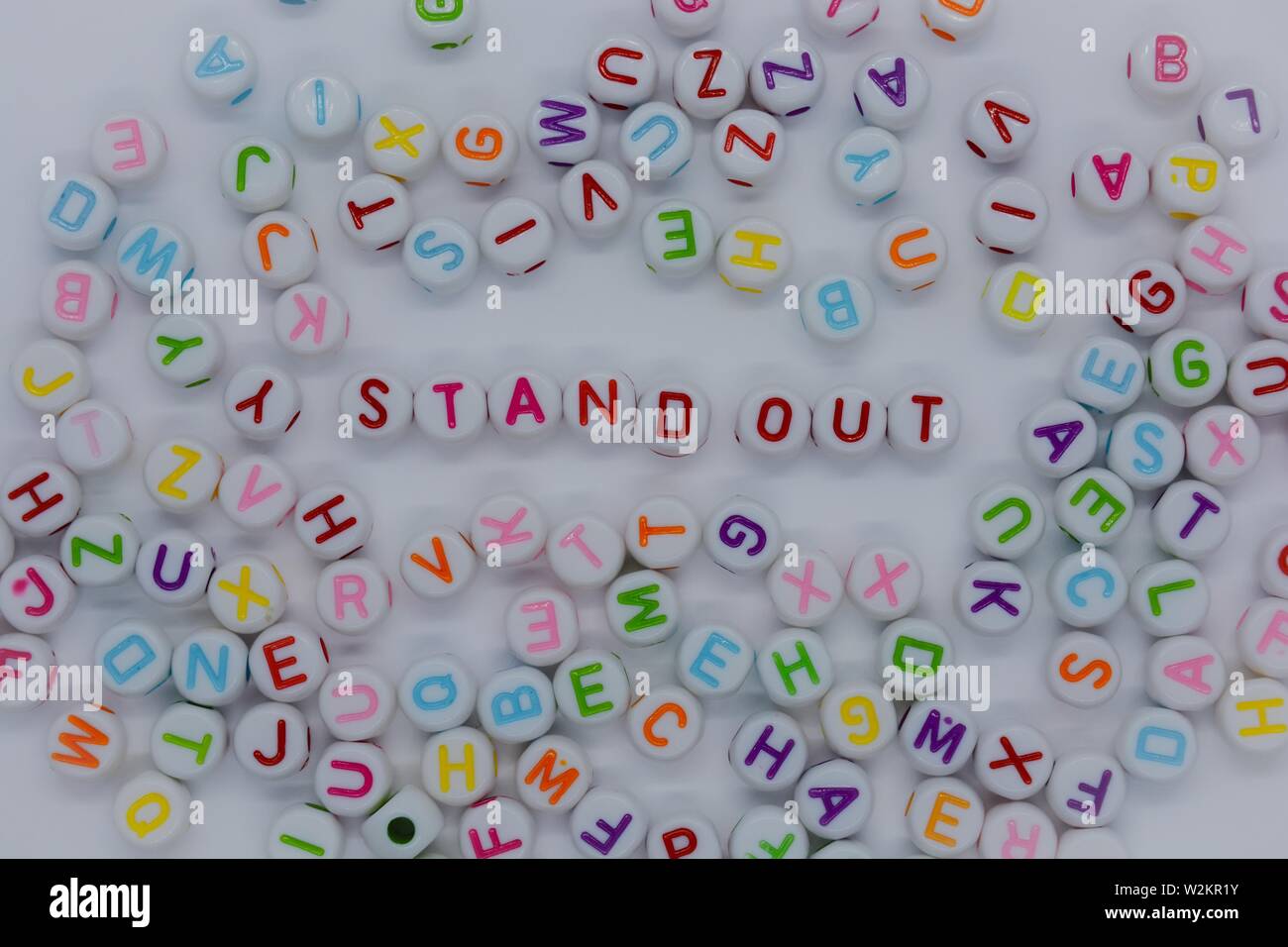 Stand Out, spelt out in red letters, surrounded by a sea of random ...