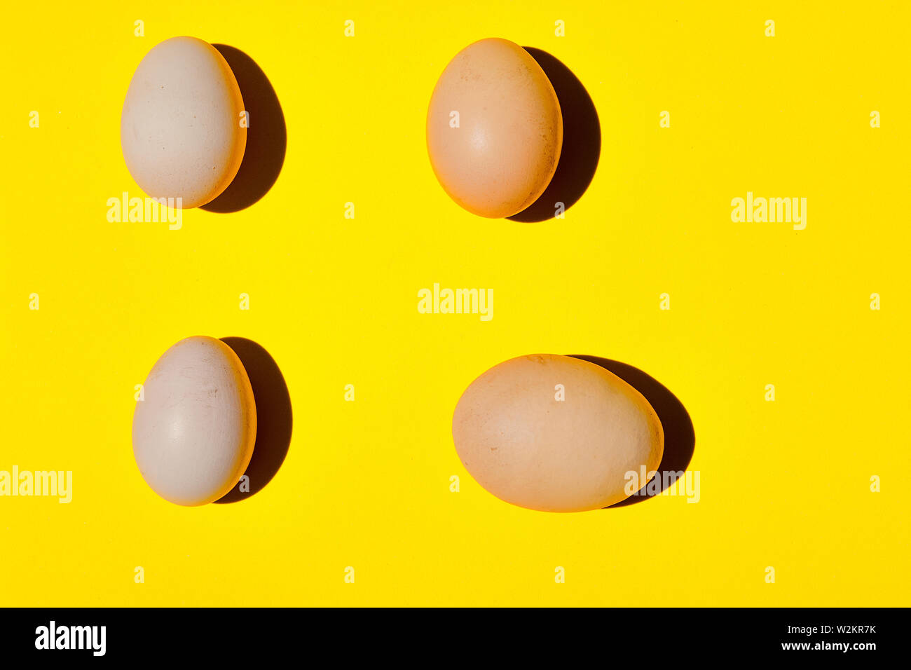 An eggs pattern. A different sizes eggs on a yellow background ...